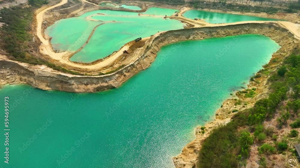 Sand quarries can appear as large open pits in the ground with steep ...