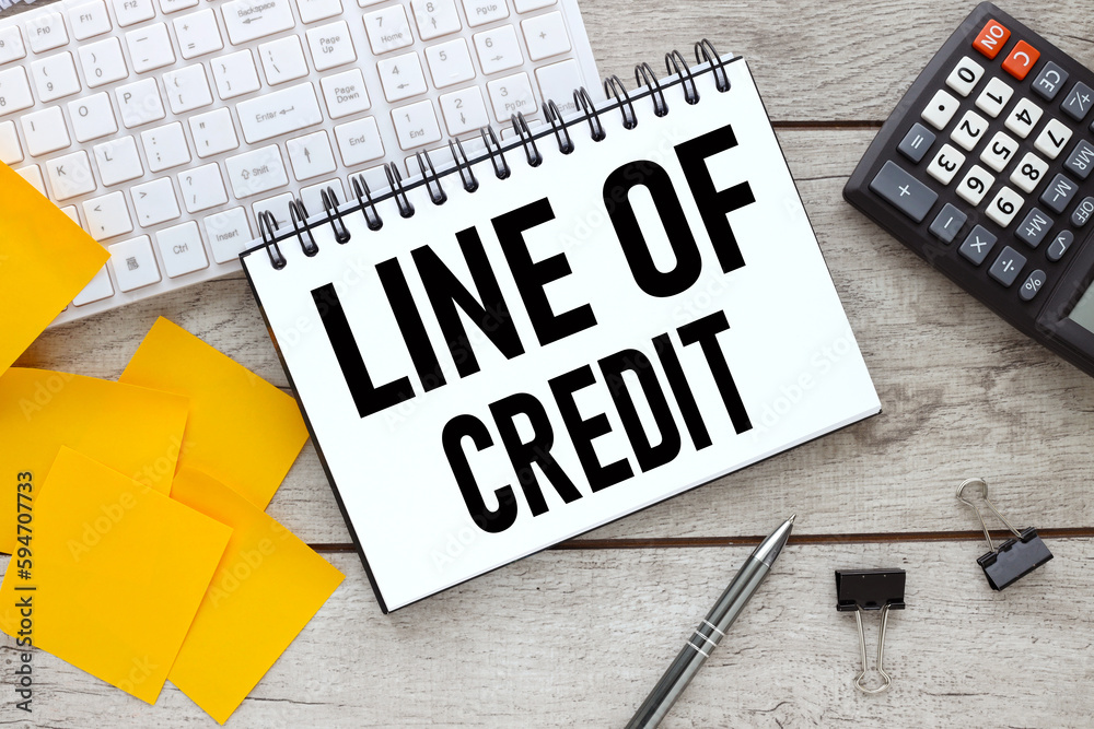 LETTER OF CREDIT text on white paper near the keyboard. light wooden ...