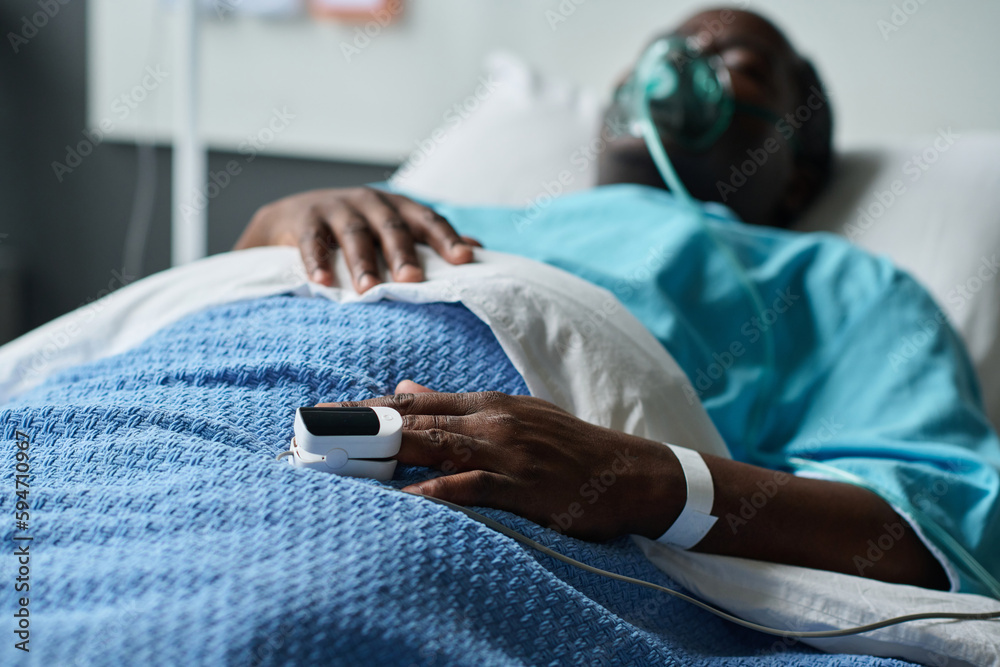 African American senior man with oxygen mask lying on bed in hospital ...