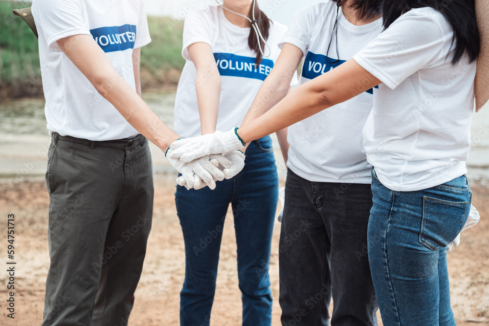 Group of diverse people volunteer team with hand stack to show teamwork spirit togetherness ...