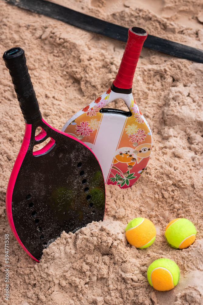 Women's and children's beach tennis rackets on the sand. Beach Tennis ...