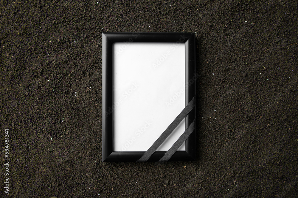 top view of picture frame on dark soil grim reaper funeral death ...