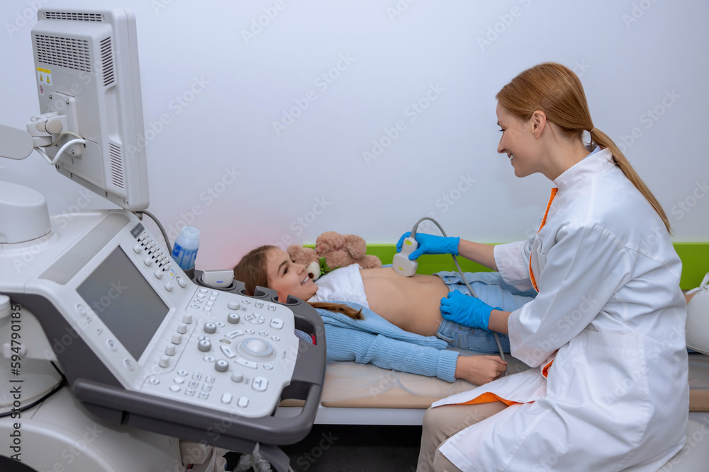 Doctor performing ultrasound scan on little girl medical specialist ...