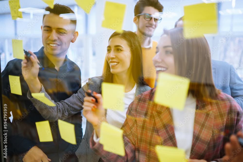 Modern group of people sharing ideas concept with paper note writing ...