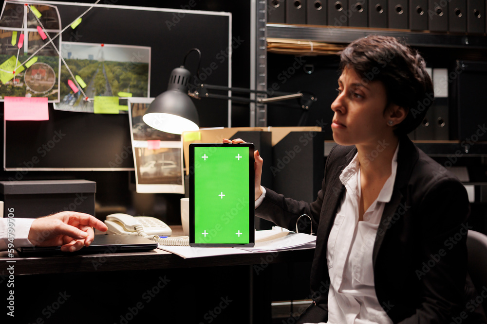 Police officer holding tablet computer with green screen mock up chroma ...