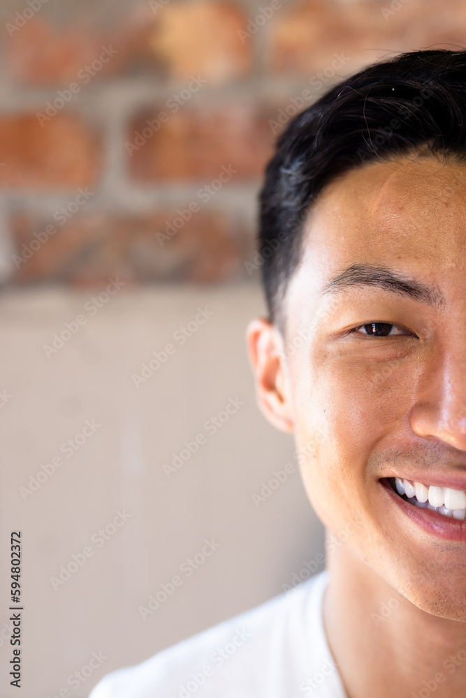 Half face portrait close up of happy asian casual businessman smiling ...