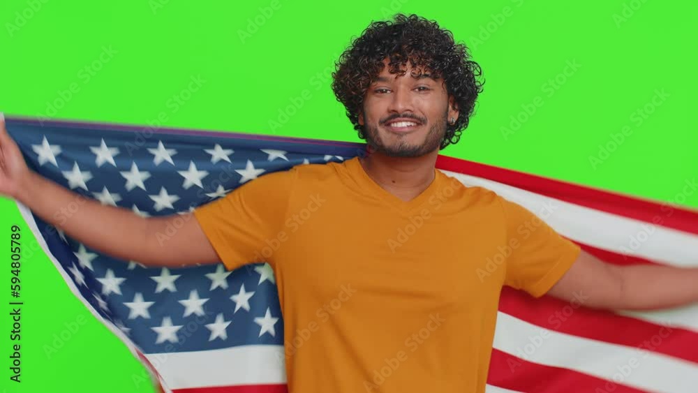 Vidéo Stock Young indian man waving and wrapping in American USA flag ...