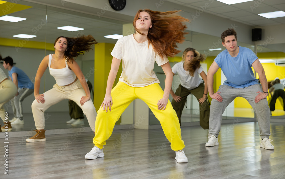 Group of young active tween dancers in casual wear performing dancing ...