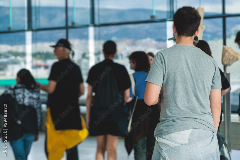 Group of students on excursion visit gallery museum with tour guide, a ...