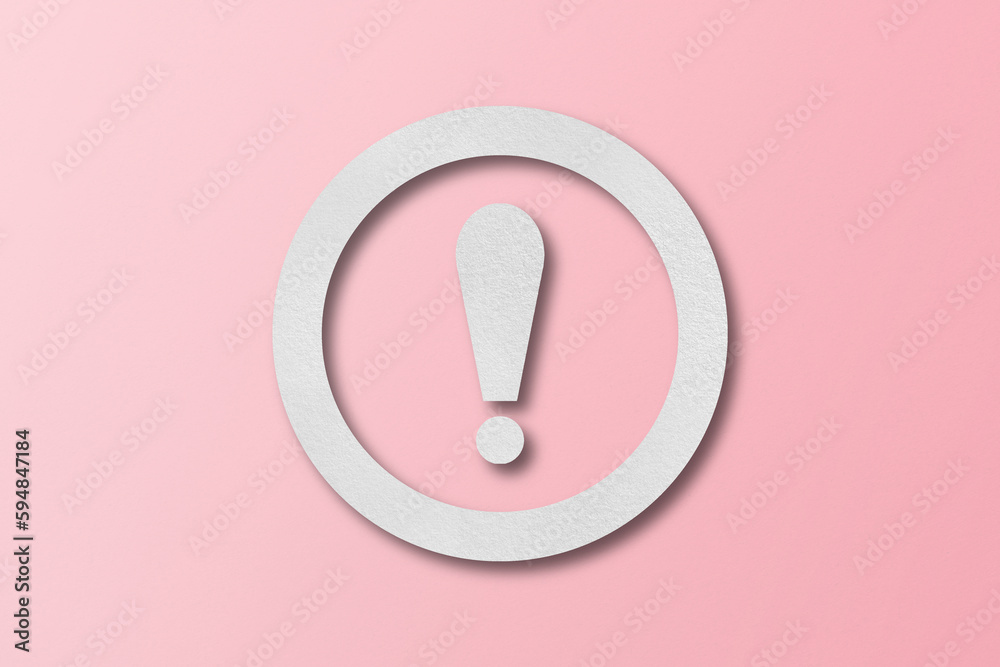 White paper punched into the shape of an exclamation mark. warning sign ...