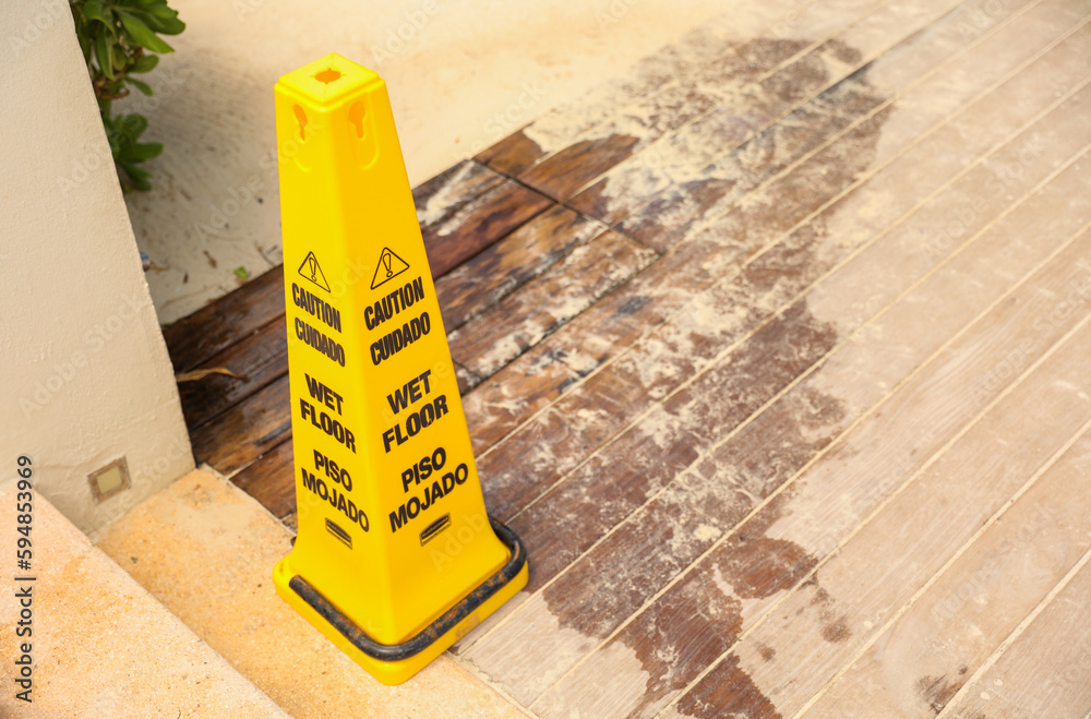 A yellow wet floor sign is a symbol of caution and warning, indicating ...