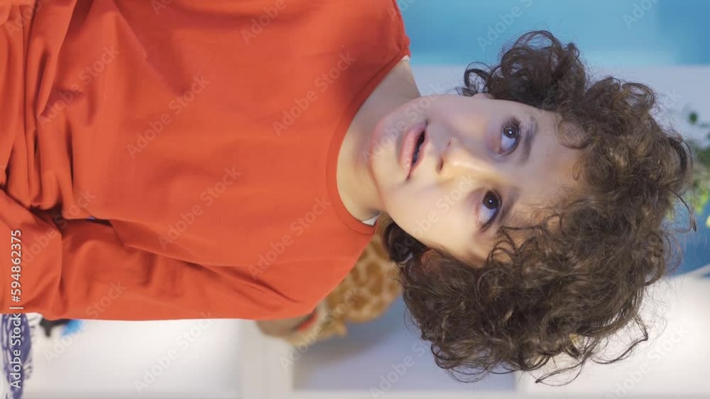 Vertical video of Unhappy boy crying in his room. Sad depressed boy crying alone in his room ...