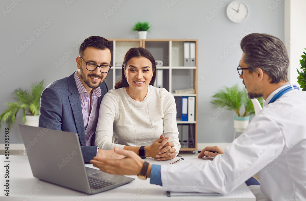 Young family couple planning children and visiting doctor. Doctor ...