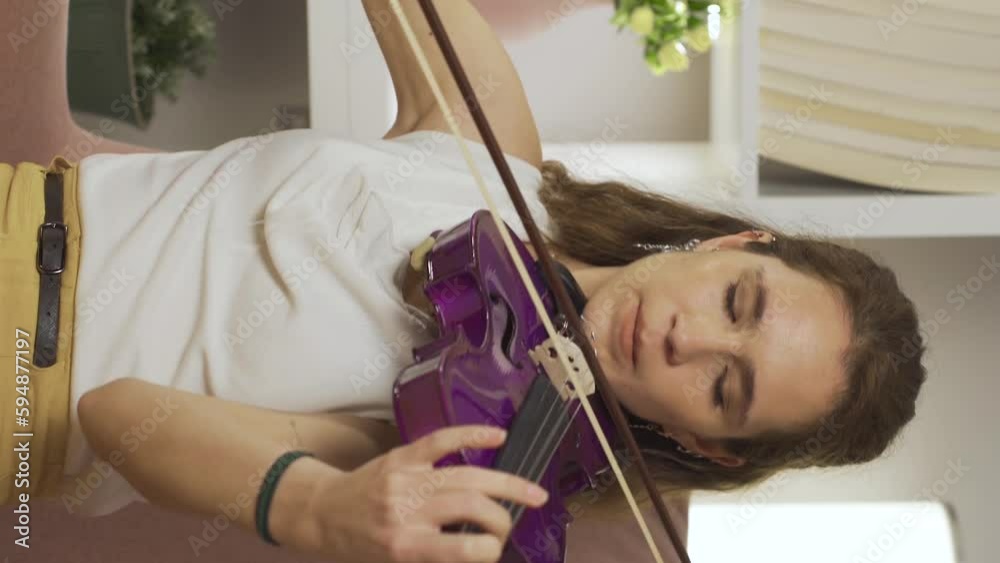 Vertical video of Talented violinist young woman playing the violin ...