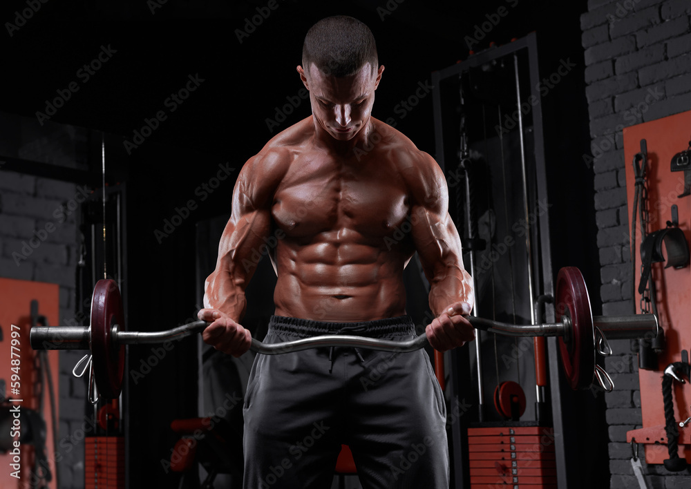 Photo & Art Print Handsome strong athletic man pumping up muscles ...