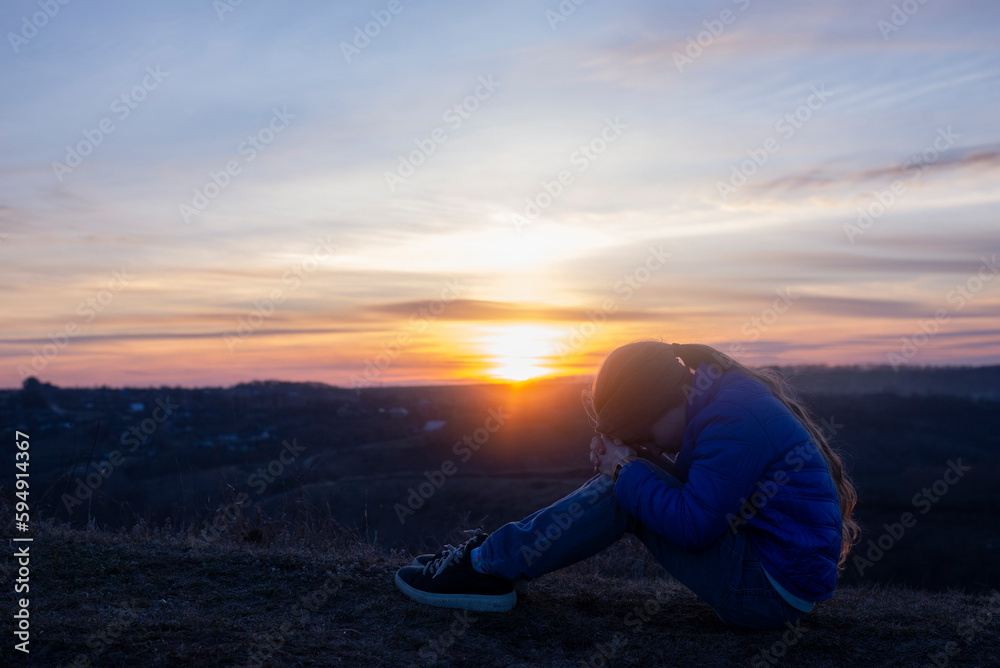 Prayer. Girl on her knees. Pray at sunset. Kneeling Repentance for sins ...