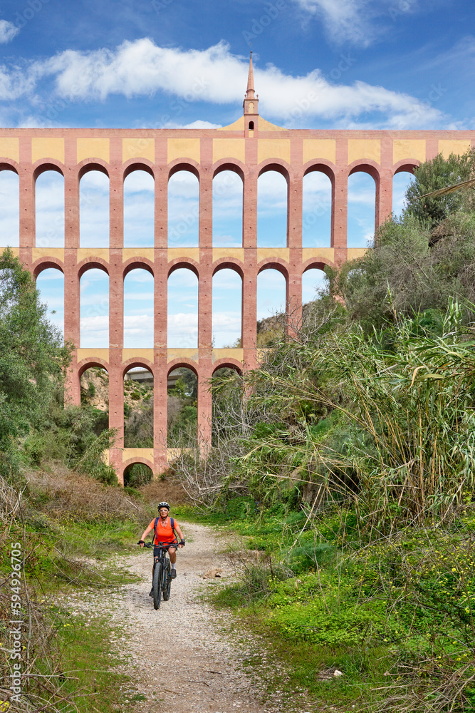 nice senior woman cycling with her electric mountain bike below the ...