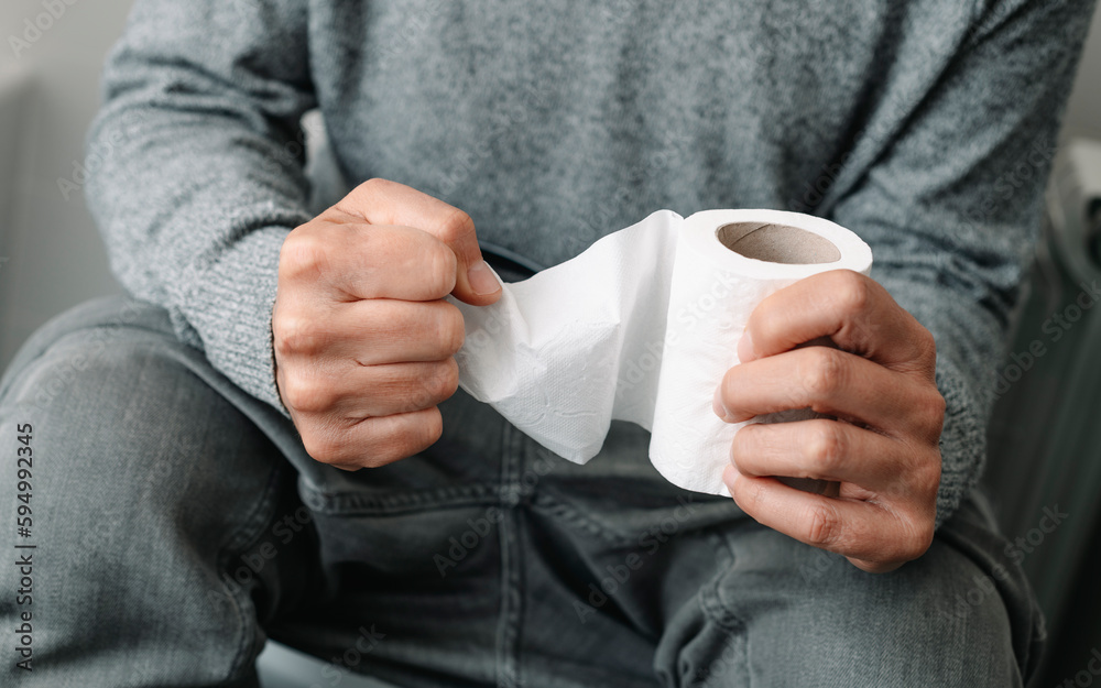 man sitting in the toilet grabs tight the toilet paper Stock Photo ...