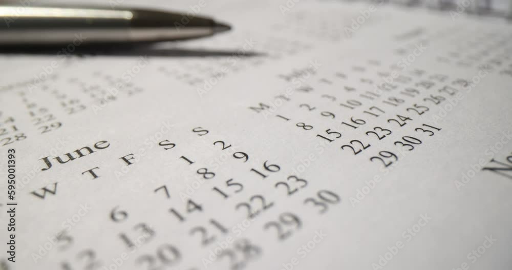 Paper calendar layout, numbers and letters, close-up. Schedule planning ...