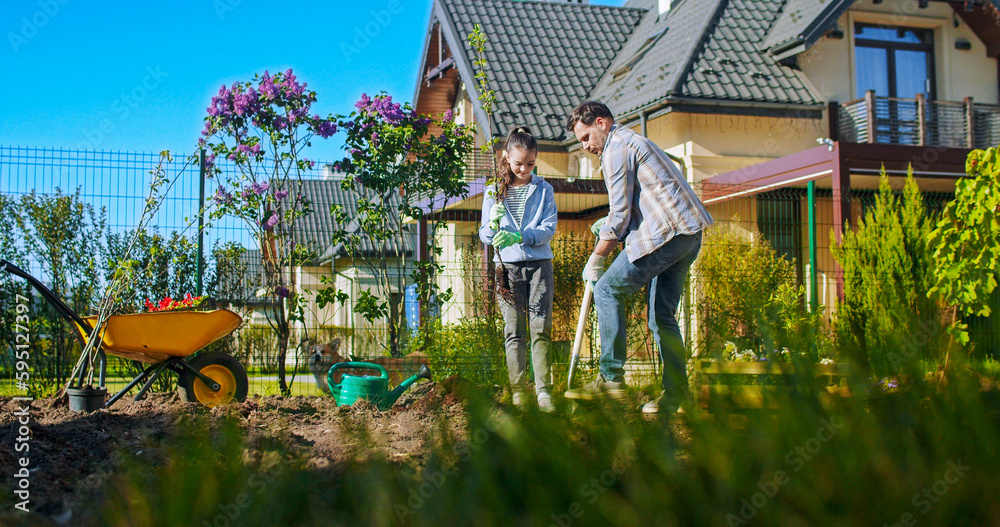 Little cute Caucasian girl helping his father in planting trees in ...