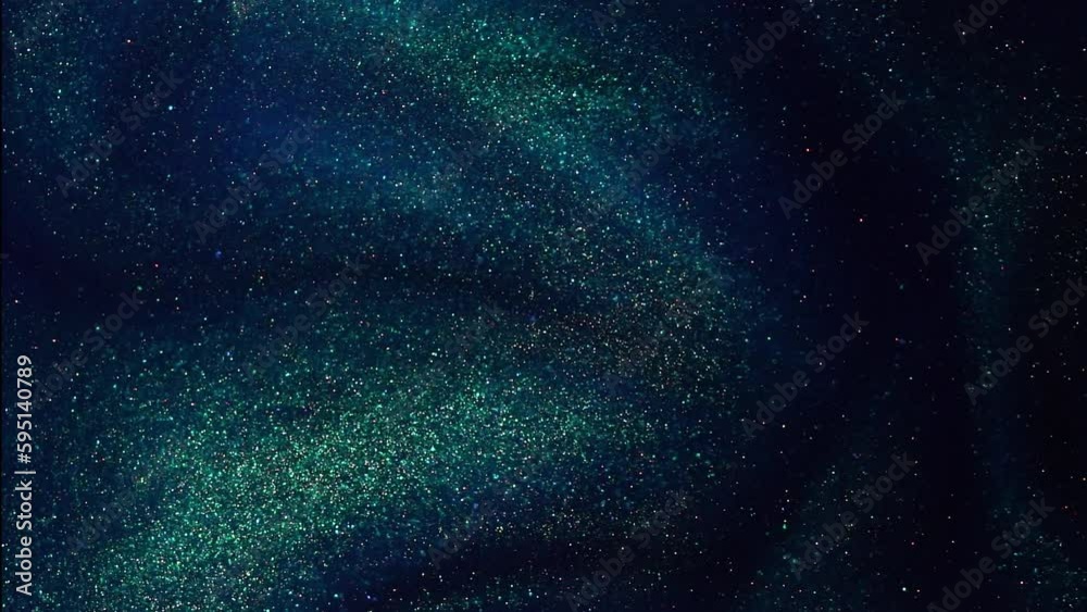 Slow-Motion Footage of Gold Dust Particles Floating in Blue Liquid with ...