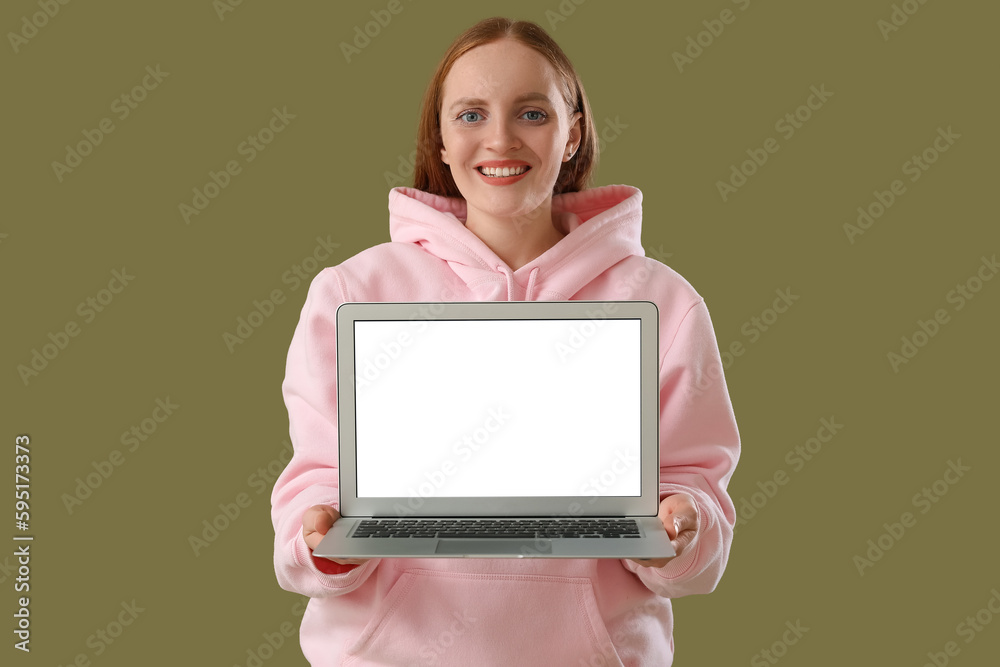 Female programmer with laptop on green background Stock Photo | Adobe Stock