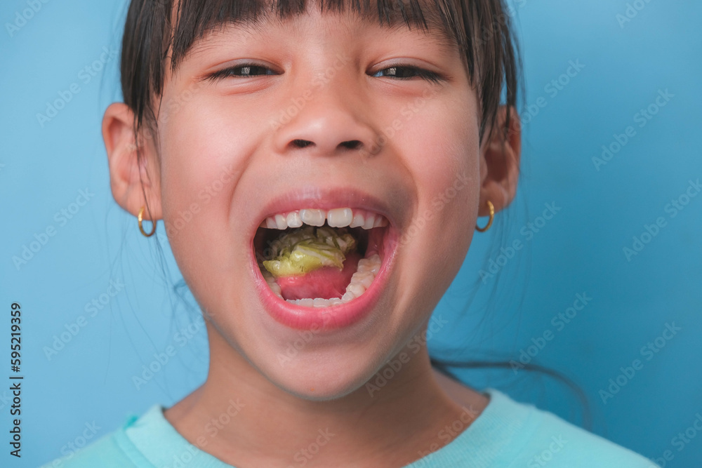 Smiling cute little girl eating sweet gelatin with sugar added isolated ...