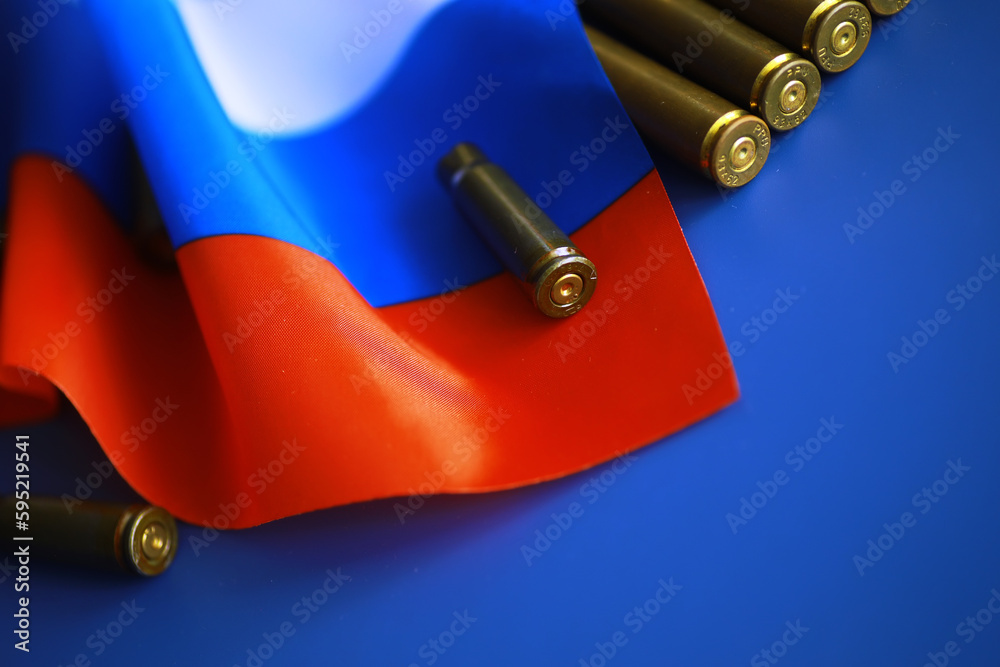 Russian flag and bullet casings on the table. Background concept ...