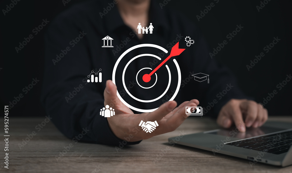 Business goal and target concept : businessman holding dartboard and ...