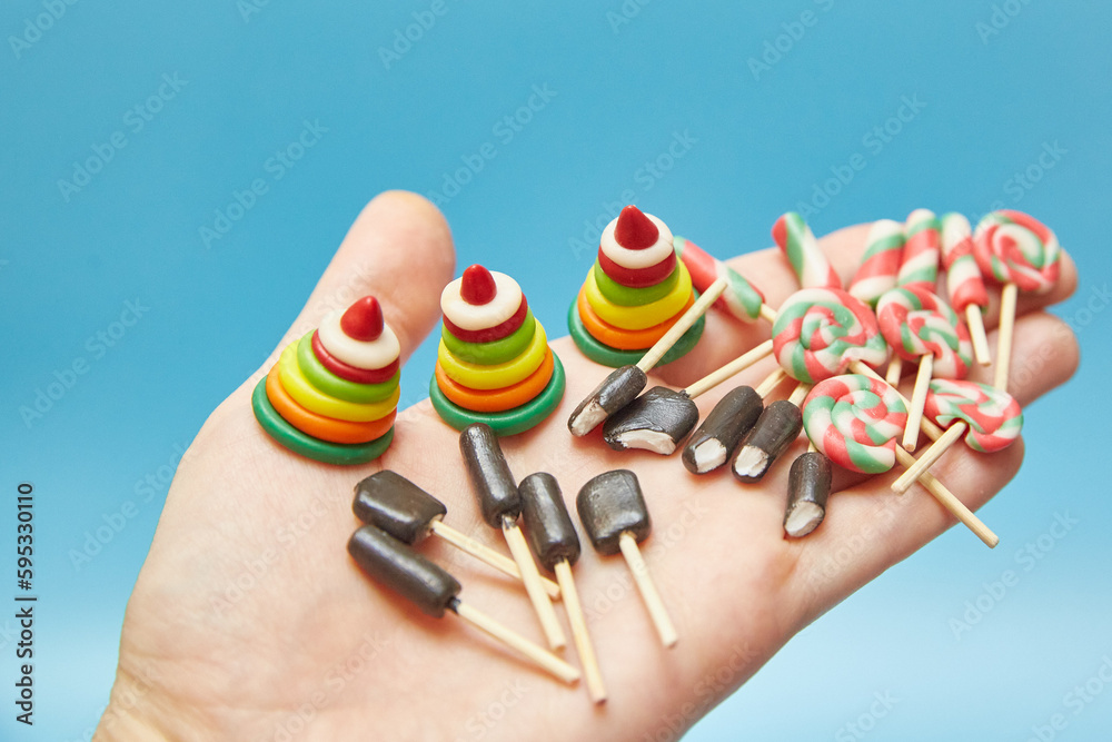 Miniature ice cream, candies and pyramids in a woman's hand. Stock ...