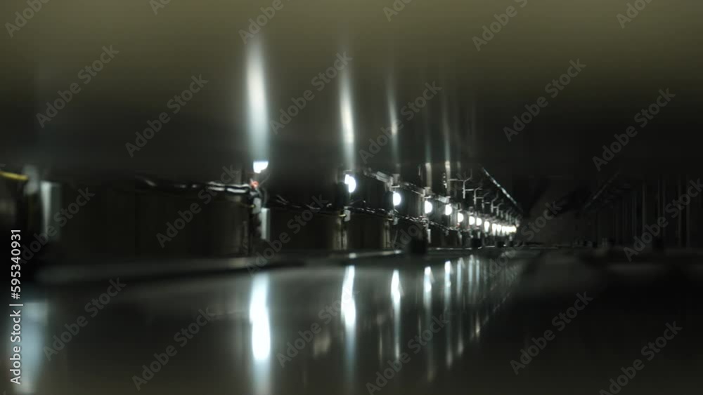 Elevator shaft with many round fluorescent lamps, nobody, panning right ...