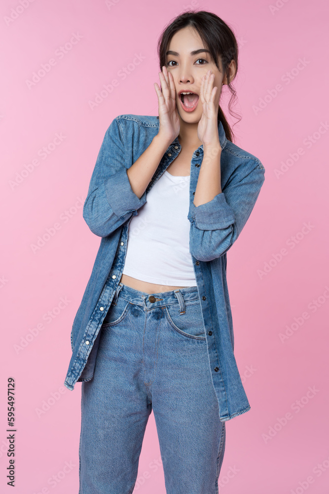 Young Asian woman doing a shocked surprise gesture shouting with hands ...