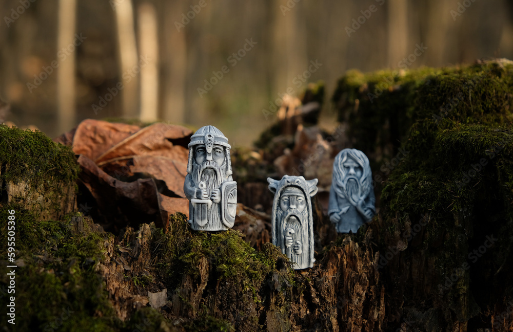 vintage ritual stone idols on tree stump close up, abstract natural ...