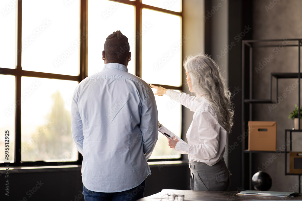 Female Talking With Male Pointing Finger At Window In Office Stock ...