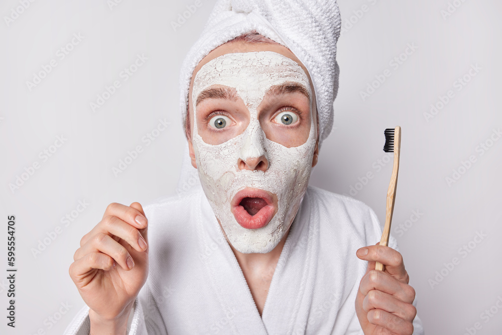 Shot of stunned scared young man stares bugged eyes keeps mouth opened ...