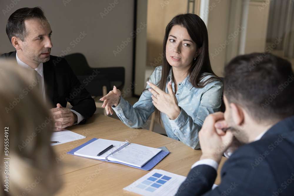 Confident business leader woman talking to colleagues on corporate ...