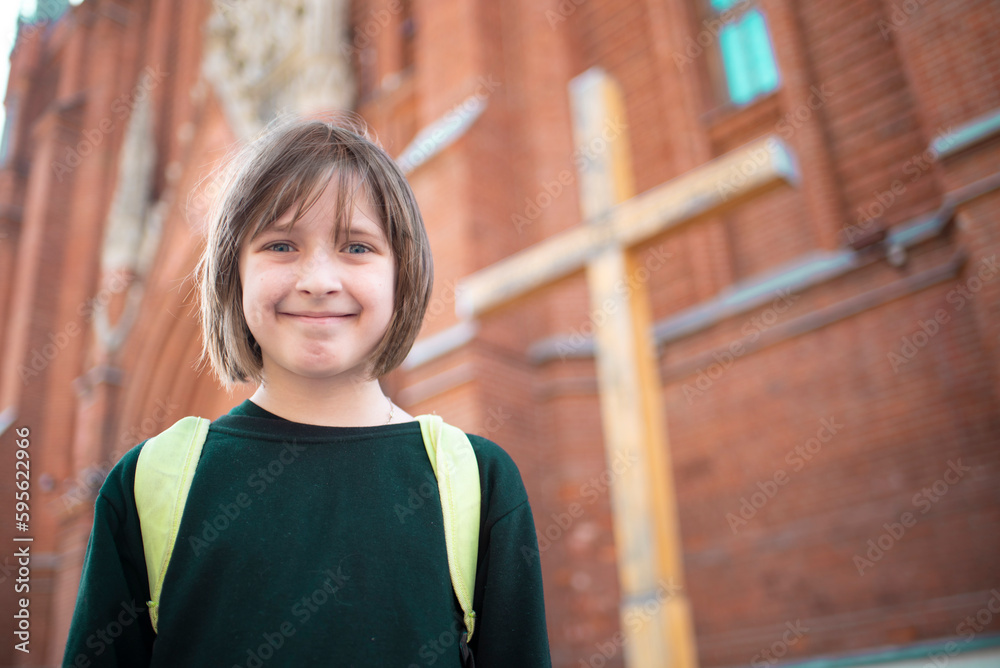 smiling happy child in goes to Sunday school in the temple, stands in ...