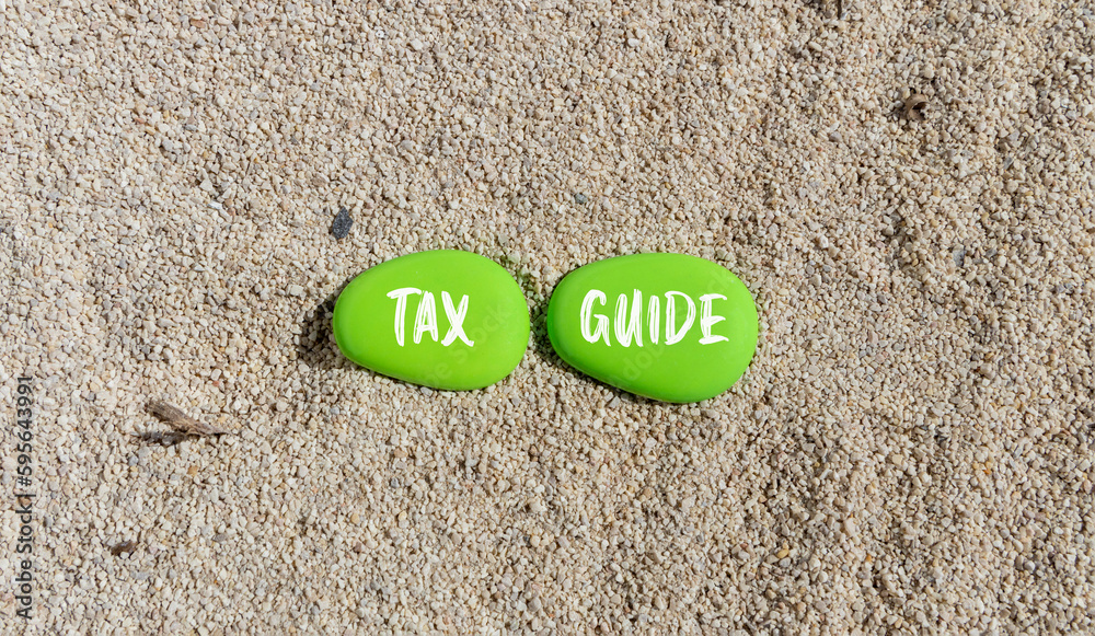 Tax guide symbol. Concept words Tax guide on beautiful green stone ...