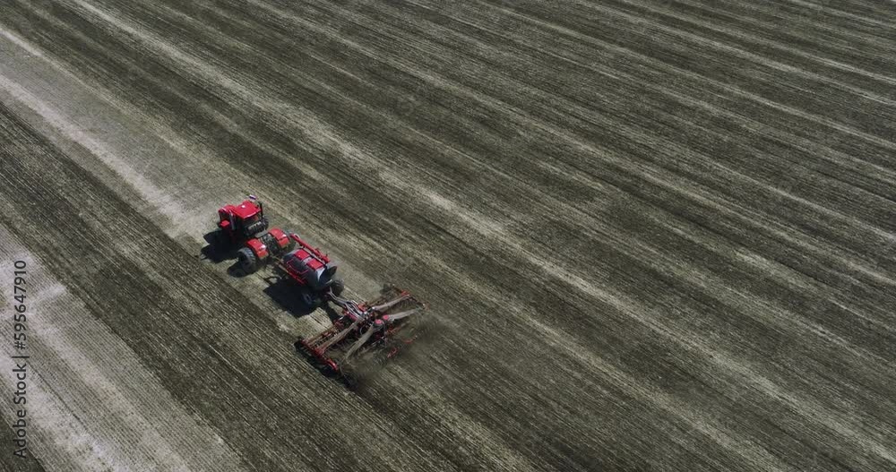 Field works. Tractor sowing seeds with seeder driller in field. Process ...