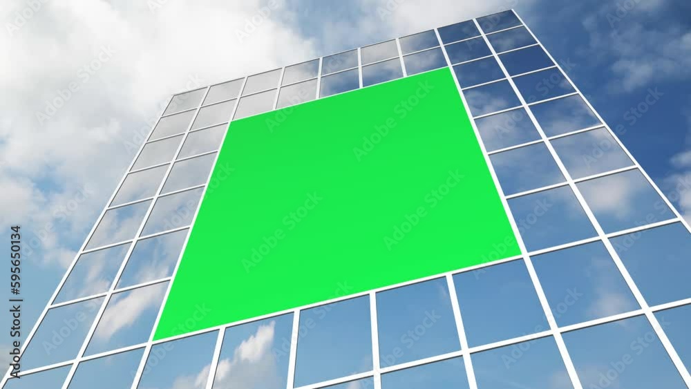 Green screen on a tall glass building with clouds reflections ...