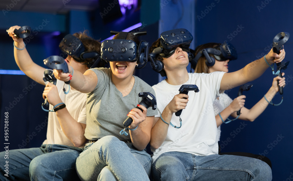 four comrades using virtual reality headset in space adventure game ...