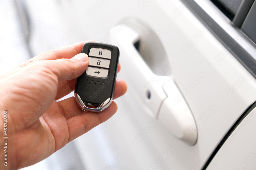 The man in the hand held the remote control of the car, he opened the ...