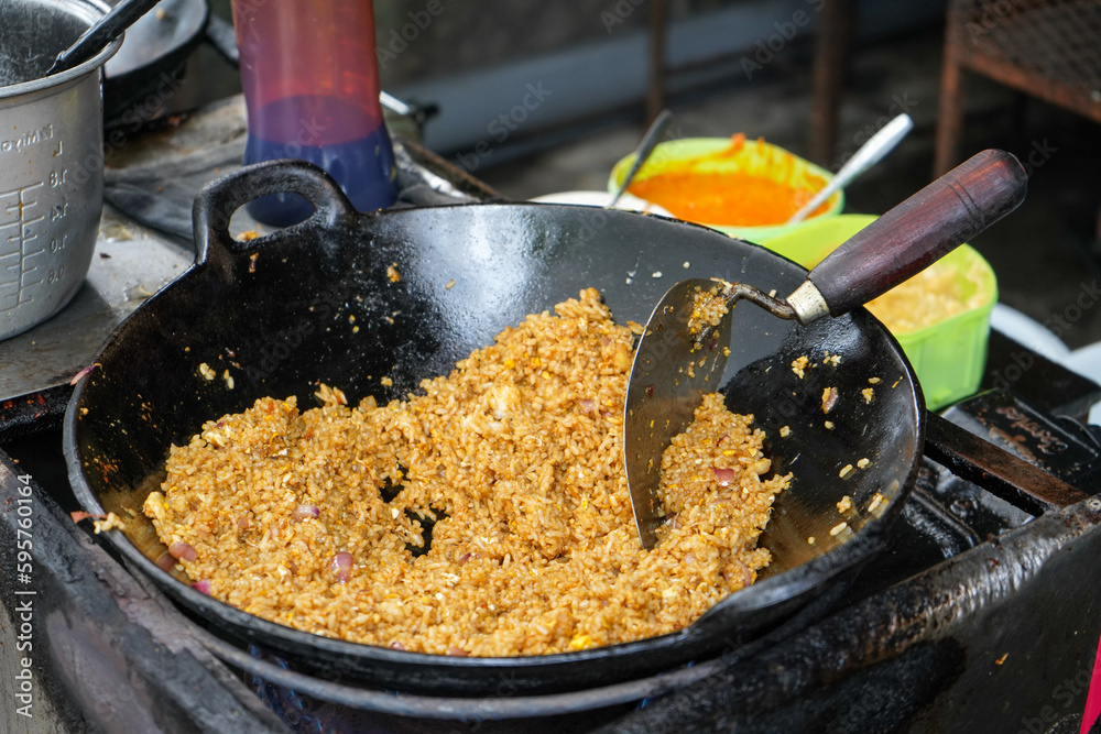 The process of cooking Javanese fried rice by a cook or chef over a ...
