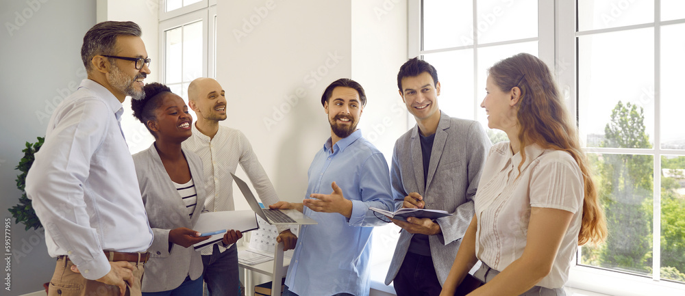 Cheerful conversation between colleagues at workplace. Group of office ...