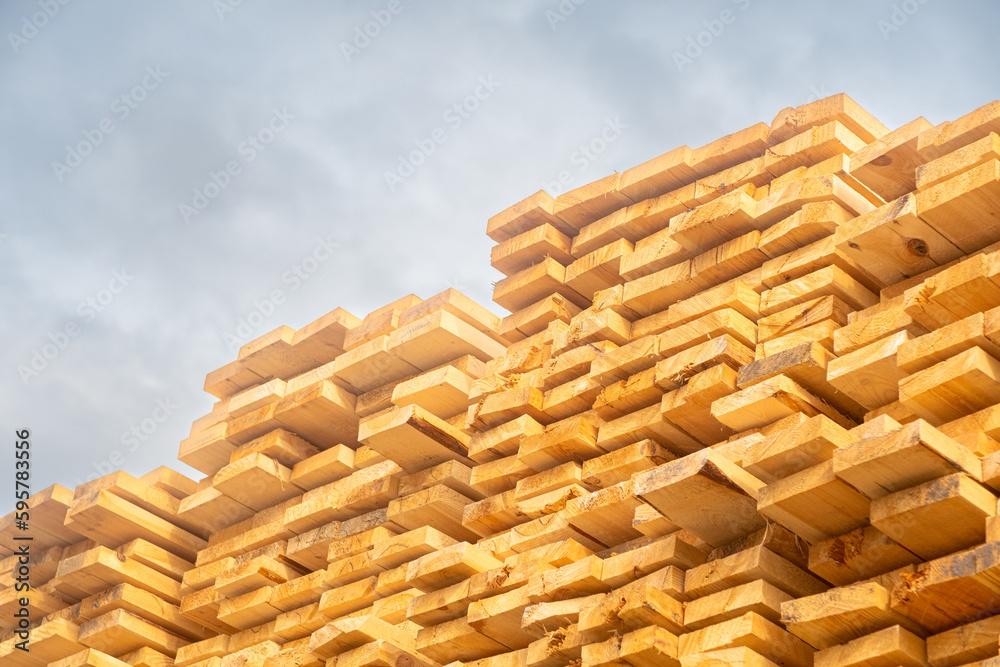 Wooden boards are stored outdoors. Wooden boards, lumber, industrial ...