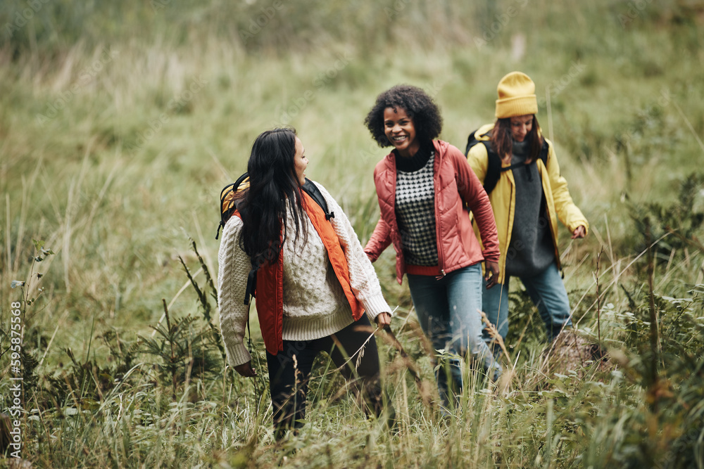 Smiling female friends hiking in nature Stock Photo | Adobe Stock