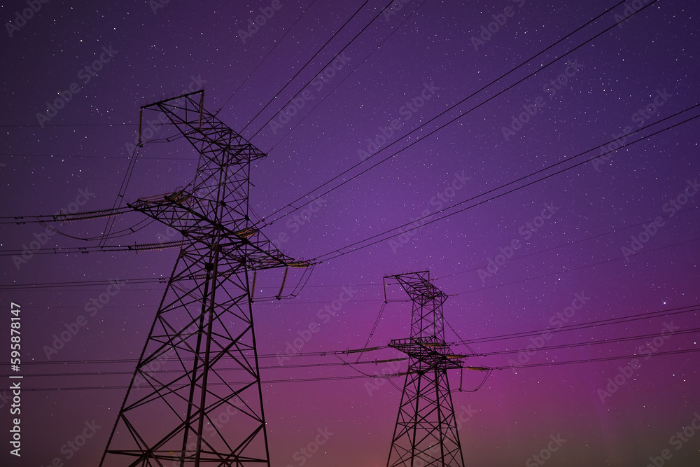 Power lines on the background of the northern lights. The power system ...