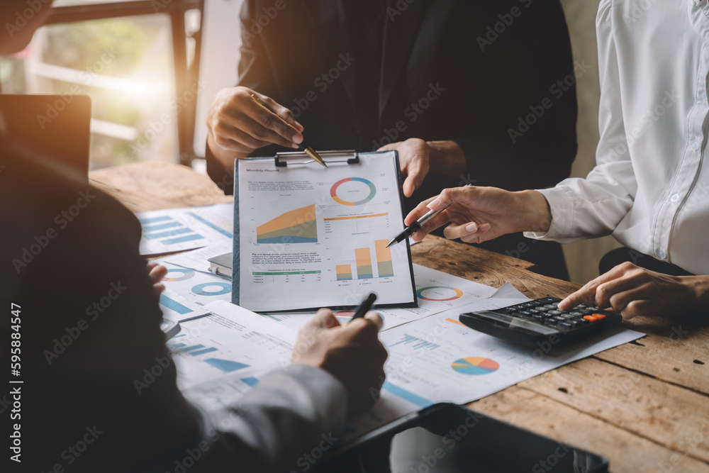 Teamwork process, Business team using a calculator to calculate the ...