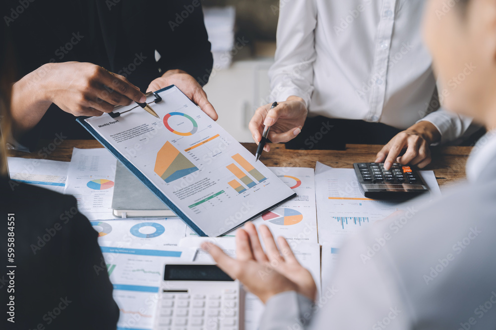 Teamwork process, Business team using a calculator to calculate the ...