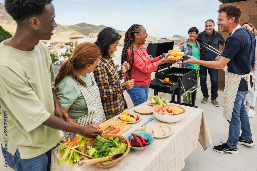 Foto de Multi generational people doing barbecue at home's rooftop ...